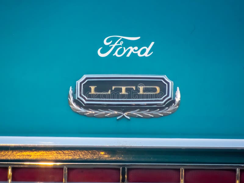 A Close-up of a Ford LTD Emblem Against a Vibrant Turquoise Backdrop ...