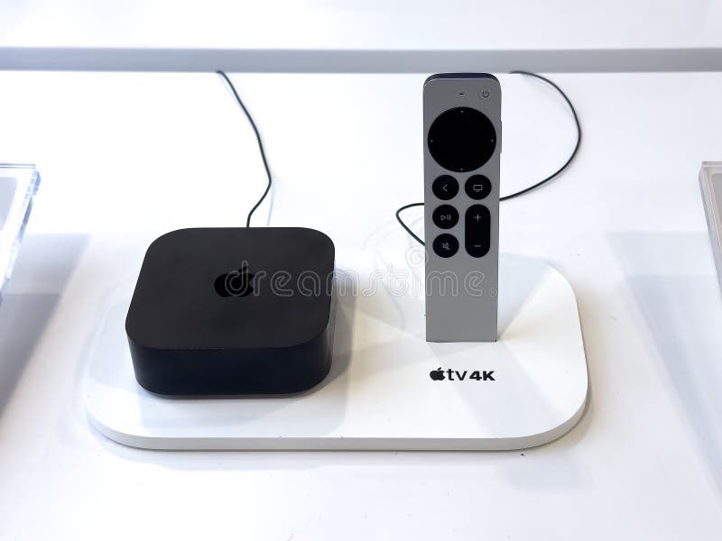 An Apple TV and Its Remote are Displayed. the Black Apple TV Box Sits ...