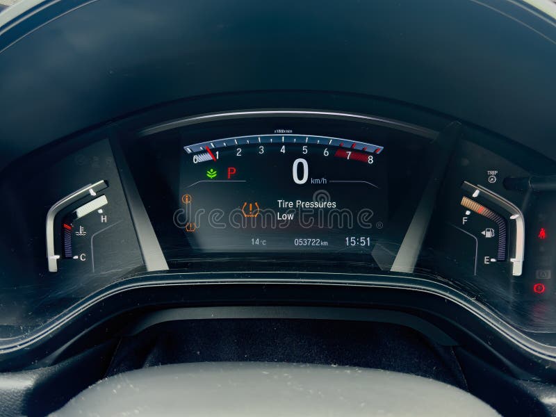 A Car Dashboard Indicating Low Tire Pressure, with the Odometer Reading ...