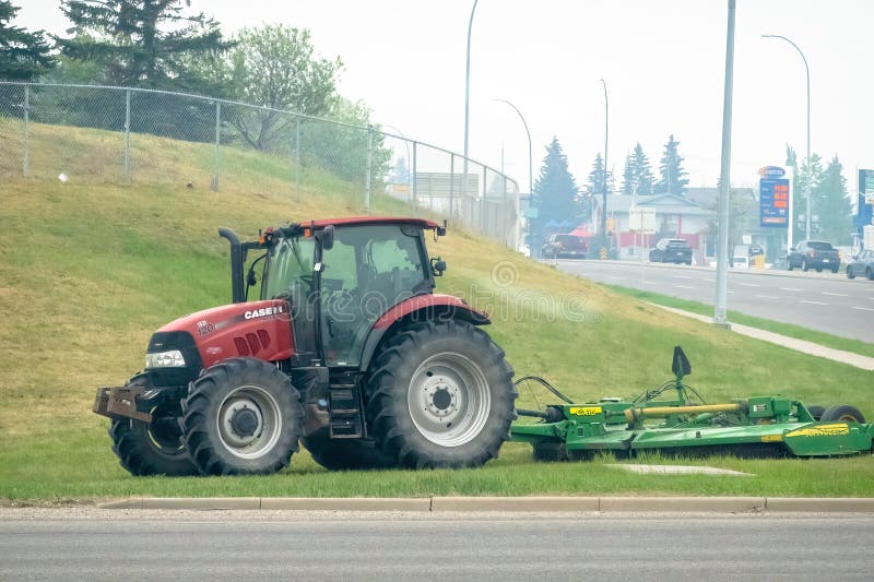 A Side View of a Tractor Mowing Grass during Spring Editorial Image ...
