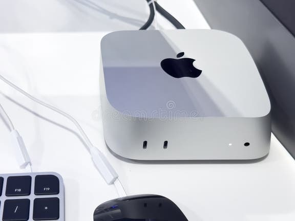 A Silver Mac Mini Computer with a Black Apple Logo. a Keyboard and ...