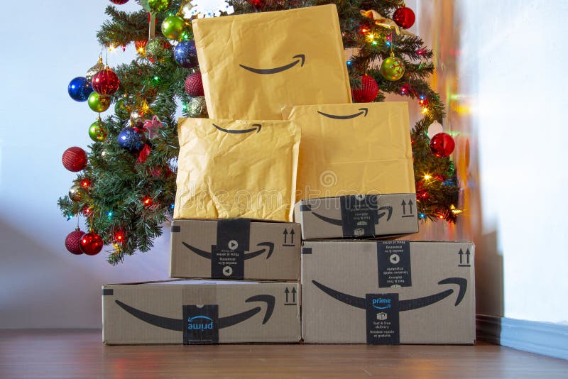 Amazon Boxes and Envelopes Under a Christmas Tree with Ornaments and ...