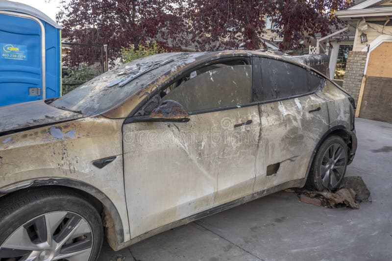 An Electric Tesla Car with Fire Damage in from a Front House Garage ...