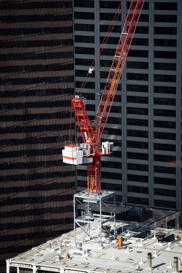 Construction Crane on the Top of a Downtown Building with a Crane ...