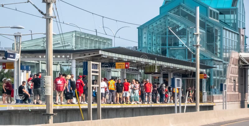 A Calgary Transit C-Train Station with a Crowd of Passengers Waiting ...
