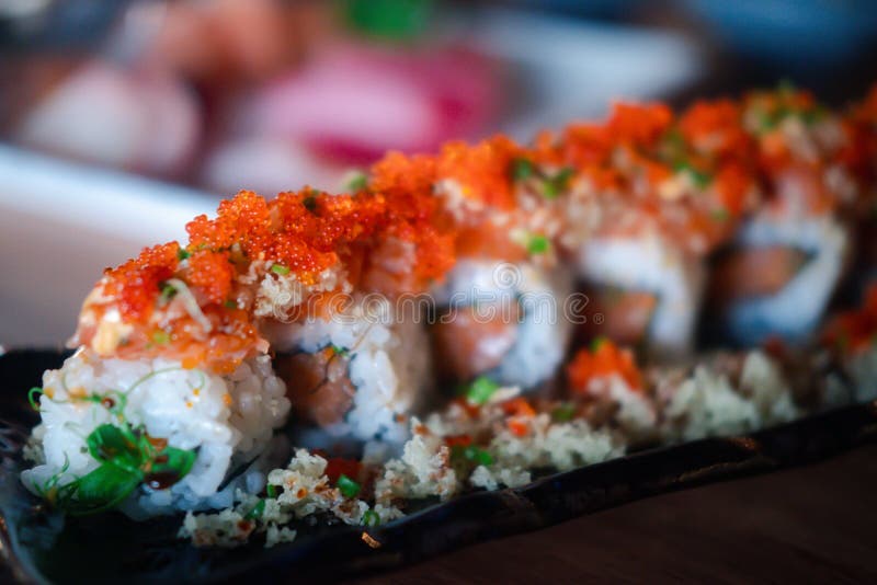 California Roll Topped with Fresh Salmon and Salmon Roe Served on ...