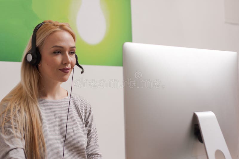 Call center agent at work stock image. Image of headset - 65939097