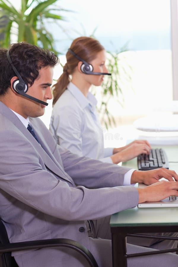 Call center agents at work stock photo. Image of speaking - 22221634