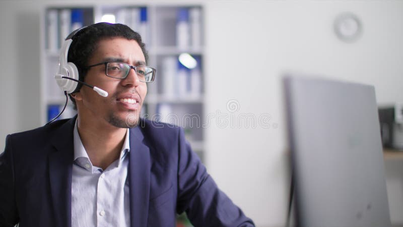 Call Center, Cheerful Black Man in Glasses and a Headset Communicates ...