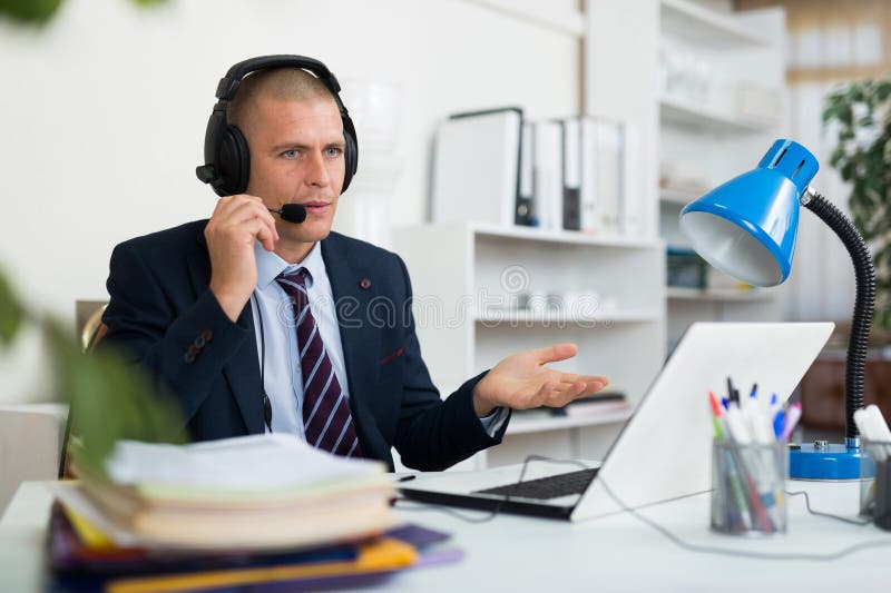 Call Center Man Operator with Headset Talking with Client in Office ...