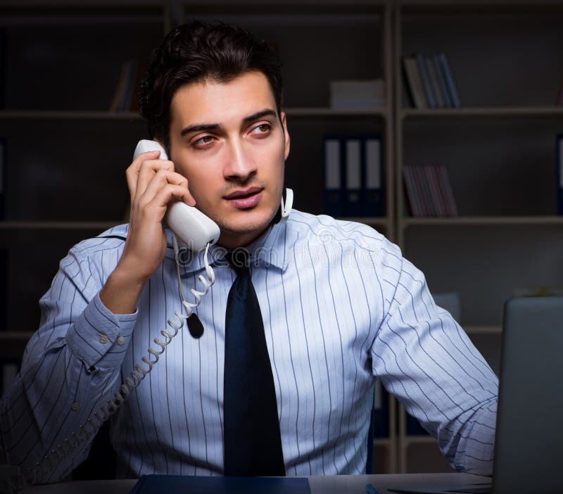 Call Center Operator Talking To Customer during Night Shift Stock Photo ...