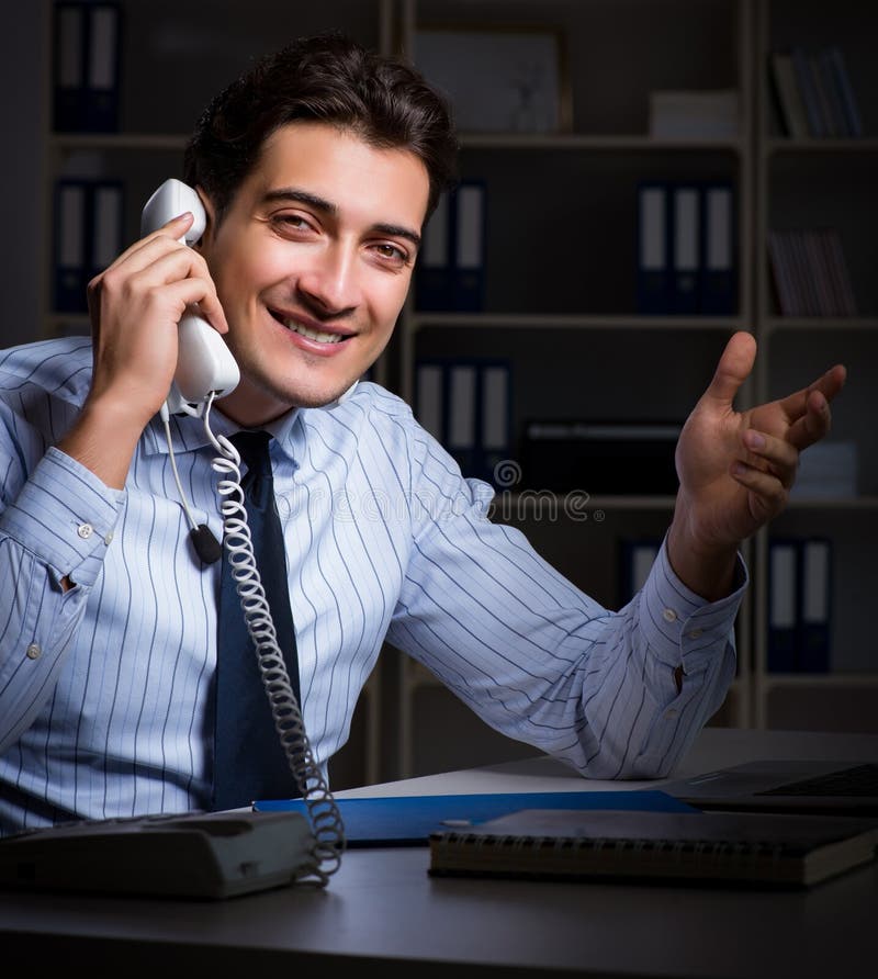 Call Center Operator Talking To Customer during Night Shift Stock Image ...