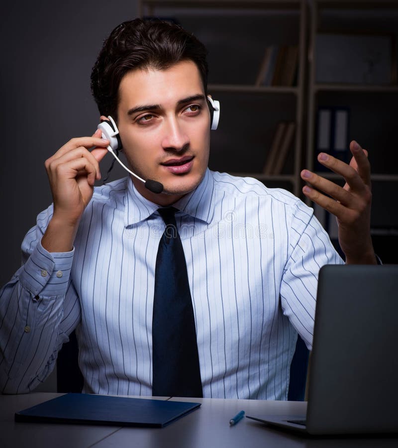 Call Center Operator Talking To Customer during Night Shift Stock Image ...