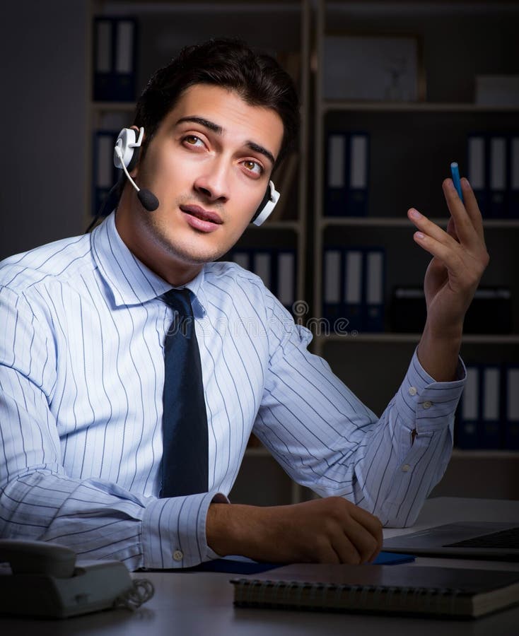 Call Center Operator Talking To Customer during Night Shift Stock Photo ...
