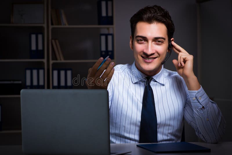 The Call Center Operator Talking To Customer during Night Shift Stock ...