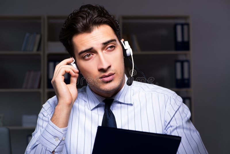 The Call Center Operator Talking To Customer during Night Shift Stock ...