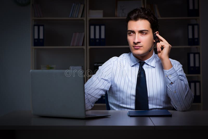 The Call Center Operator Talking To Customer during Night Shift Stock ...