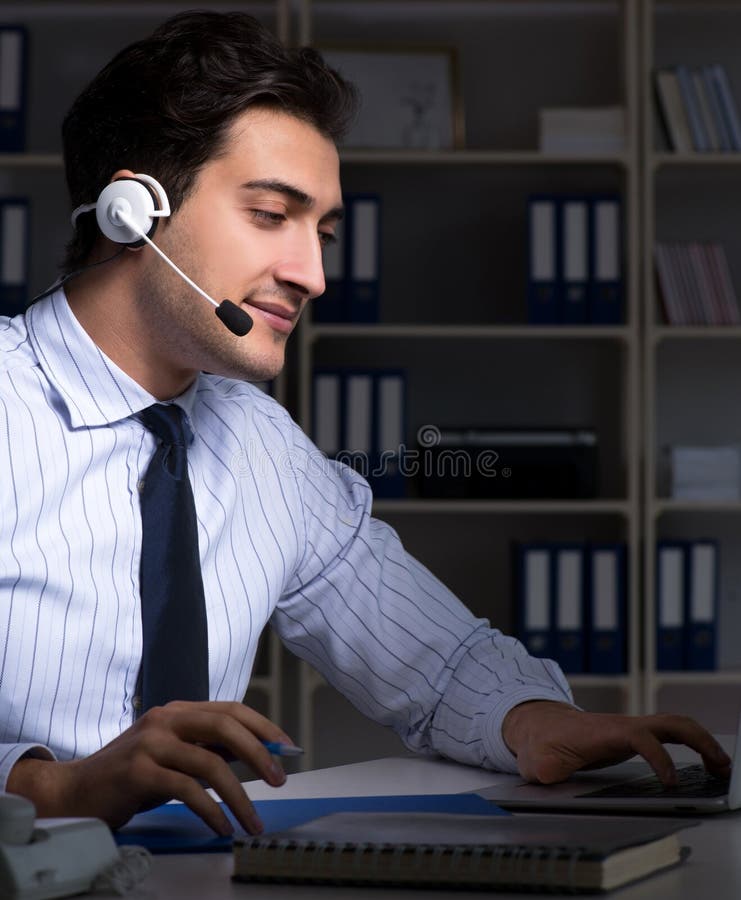 Call Center Operator Talking To Customer during Night Shift Stock Photo ...