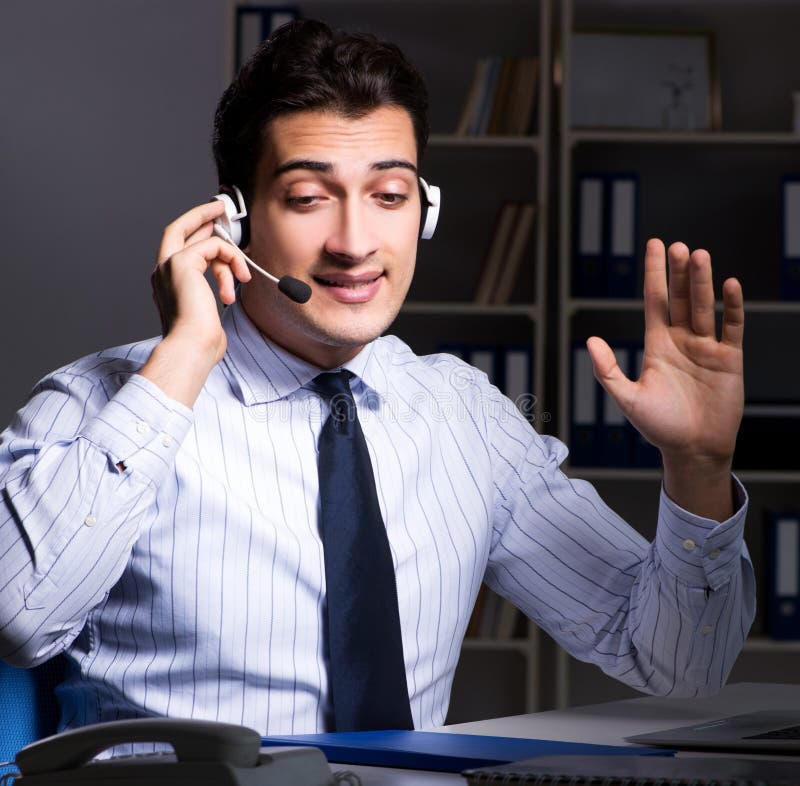 Call Center Operator Talking To Customer during Night Shift Stock Photo ...