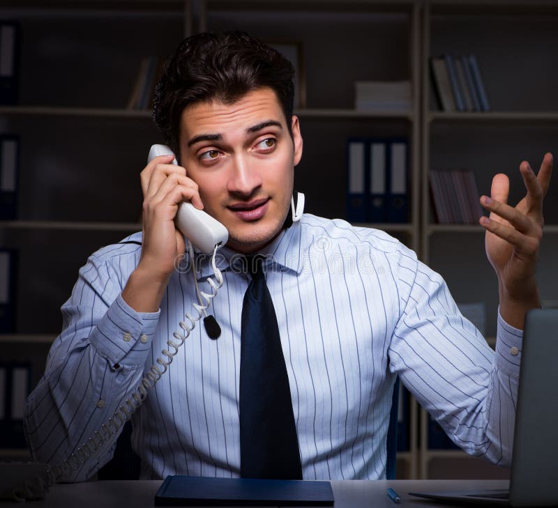 Call Center Operator Talking To Customer during Night Shift Stock Image ...