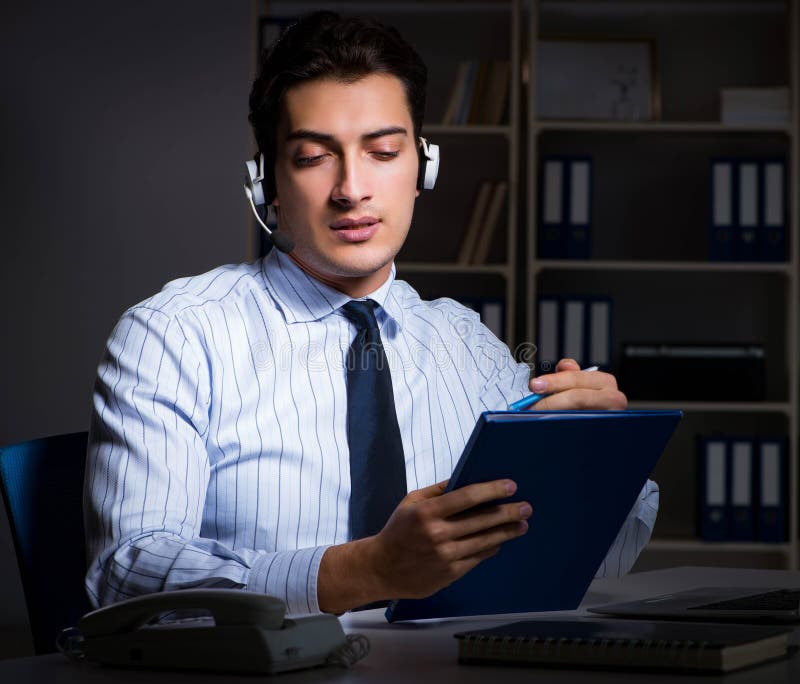 Call Center Operator Talking To Customer during Night Shift Stock Image ...