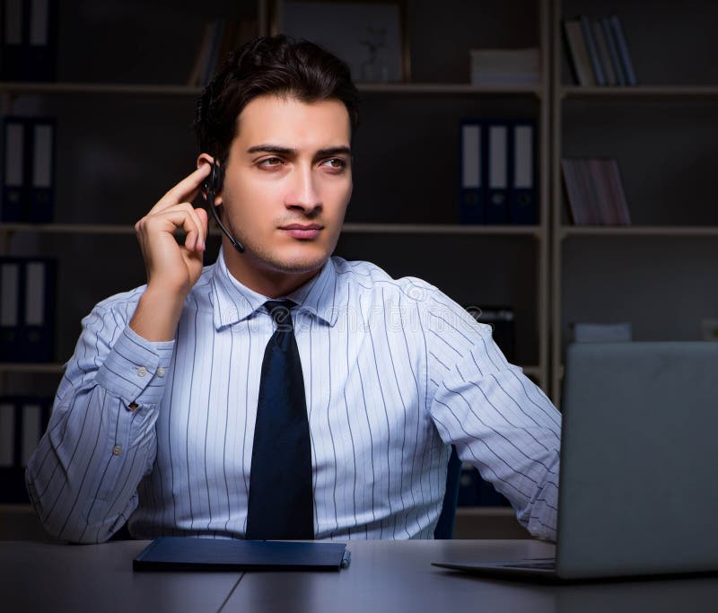 Call Center Operator Talking To Customer during Night Shift Stock Image ...