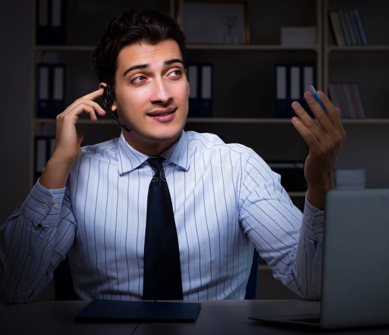 Call Center Operator Talking To Customer during Night Shift Stock Image ...