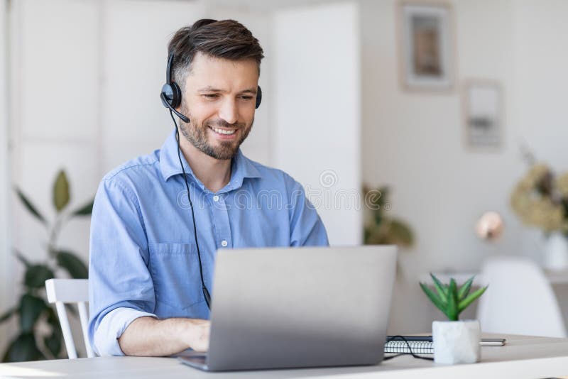 Call Center Operator at Work. Male Manager Wearing Headset and Using ...