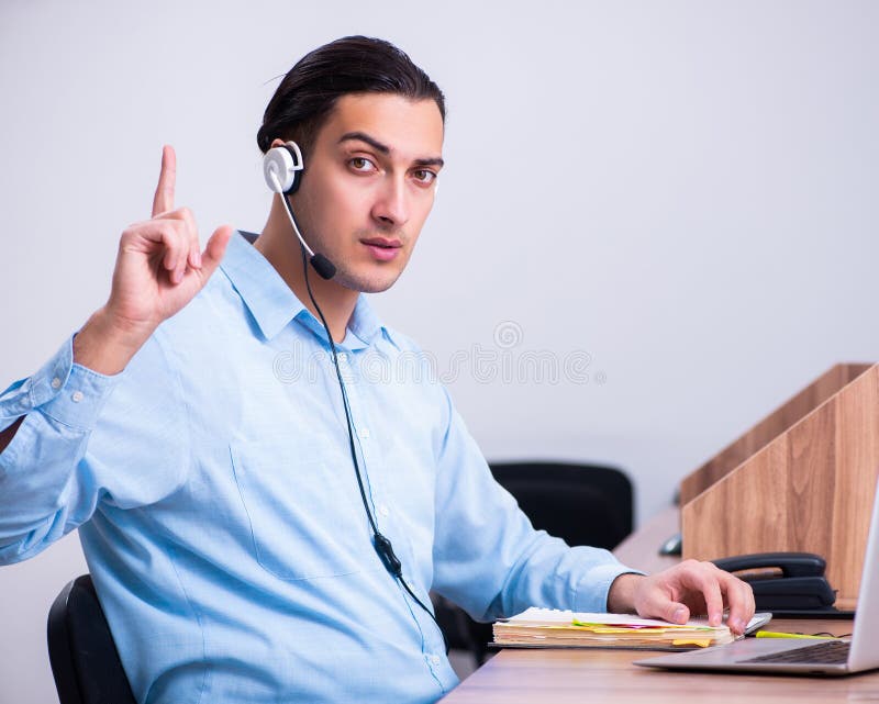 Call Center Operator Working at His Desk Stock Photo - Image of call ...
