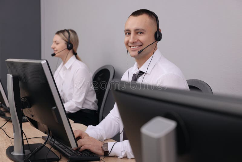 Call Center Operators with Headsets Working in Modern Office Stock ...