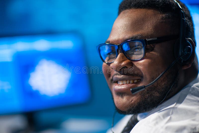 Call-center Worker is Speaking with the Client by Headset. Workplace of ...