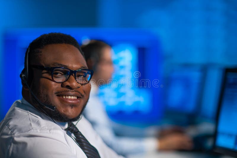 Call-center Worker is Speaking with the Client by Headset. Workplace of ...