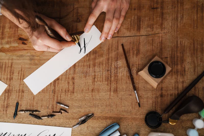 Calligrapher Writing while Working at Table Indoors Stock Image - Image ...