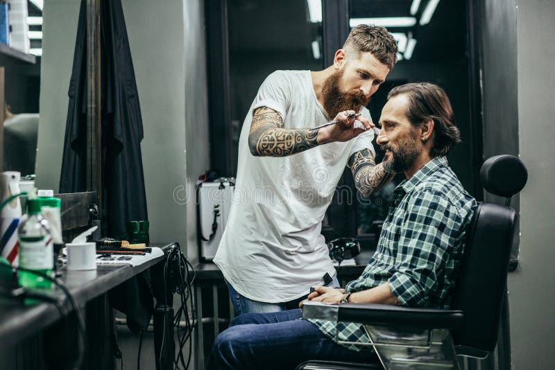 Cheerful Man Smiling and Professional Barber Combing His Beard Stock ... Cheerful Man Smiling and Professional Barber Combing His Beard Stock ...