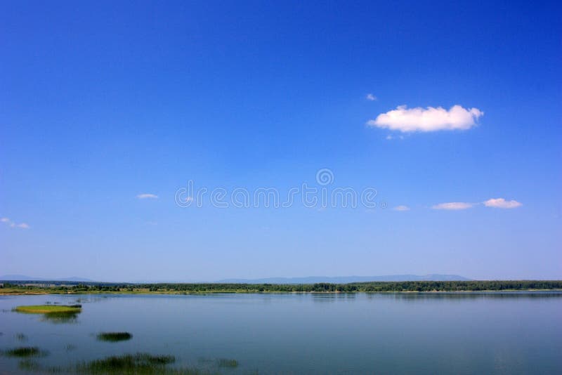 The Calm Blue Surface of the Lake Under the Blue Sky Stock Image ...