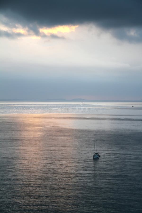 Calm Evening Sea with a Yacht in Front of a Thunder-storm Stock Image ...