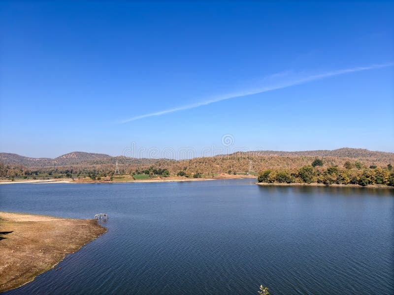 A Calm Lake with a Blue Sky in the Background Stock Photo - Image of ...