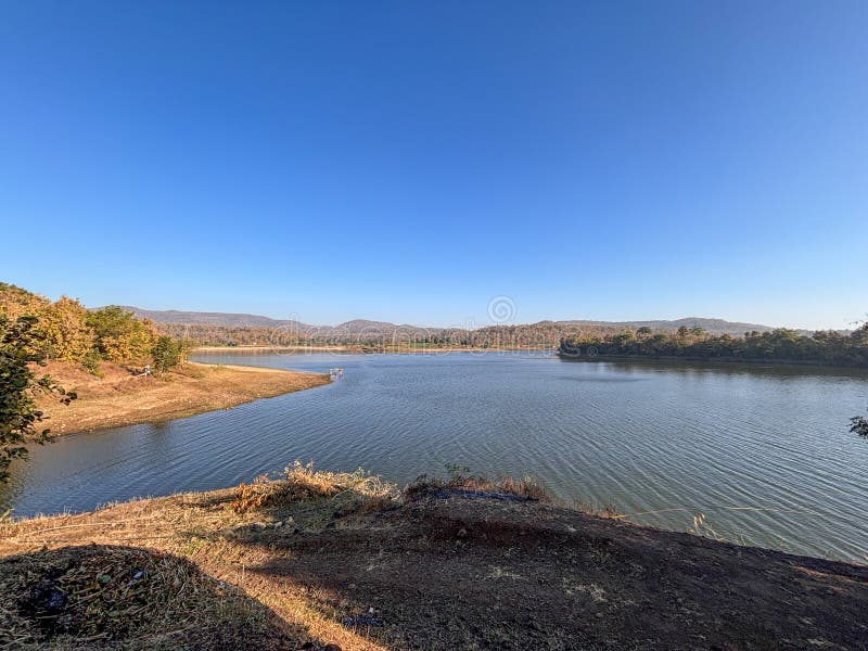 A Calm Lake with a Blue Sky in the Background Stock Photo - Image of ...