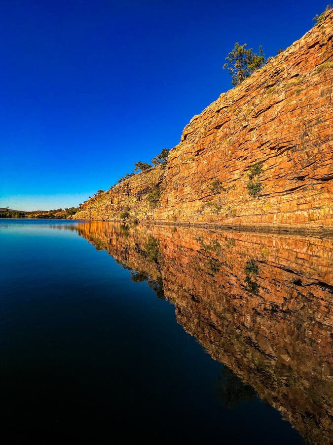 Calm Lake Next To a Rocky Cliff in Spring Stock Photo - Image of water ...