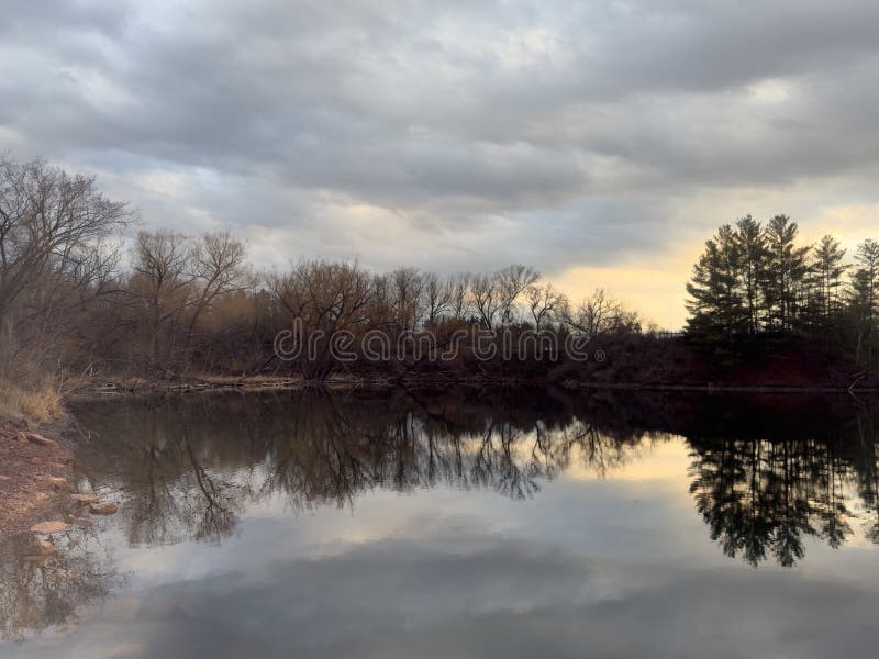 Reflections of Trees in the Lake at Sunset in Michigan Stock Image ...