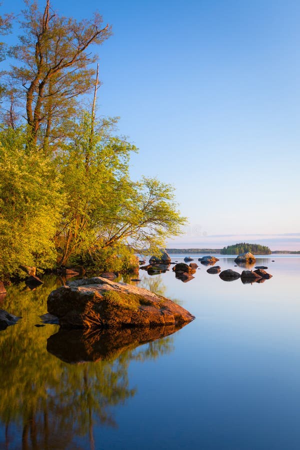 Calm lakeside at sunset stock photo. Image of lakefront - 112158036