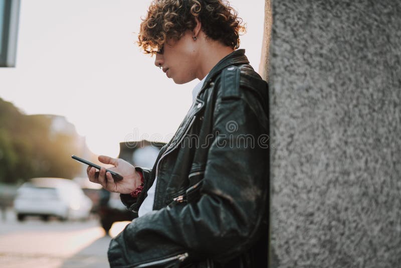 Calm Man by the Wall Using Smartphone Stock Image - Image of spring ...