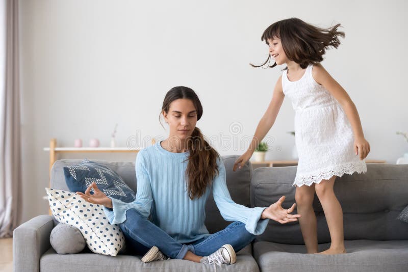 Calm Mom Doing Yoga while Kid Jumping on Sofa Stock Image - Image of ... Calm Mom Doing Yoga while Kid Jumping on Sofa Stock Image - Image of ...