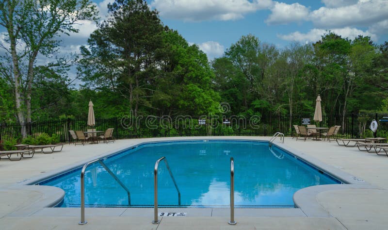 Calm Neighborhood Pool stock image. Image of lounges - 189379183