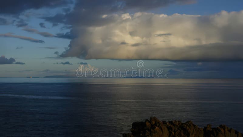 Dramatic Sky Over Serene Ocean at Sunset with Distant Islands. Stock ...