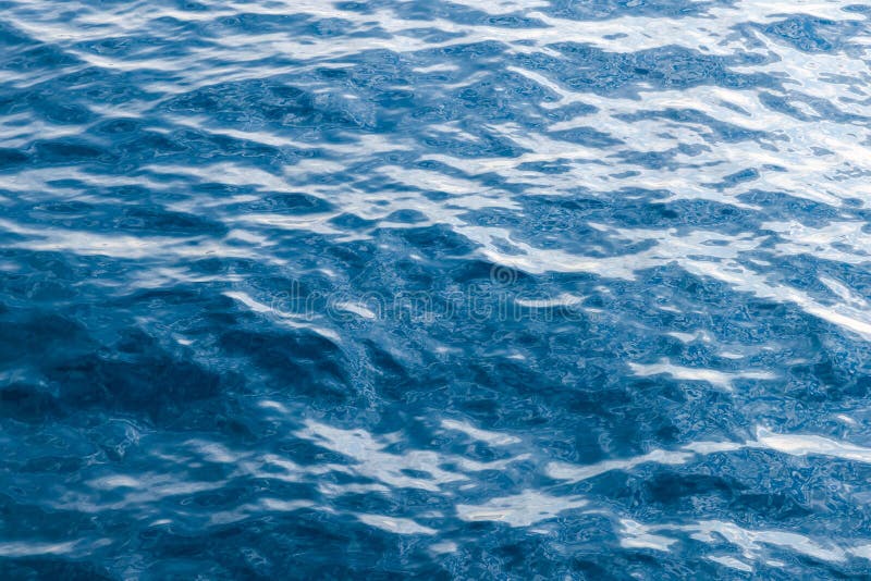 Calm Ocean Scene Showcasing the Interplay of Sunlight on Rippling Water ...