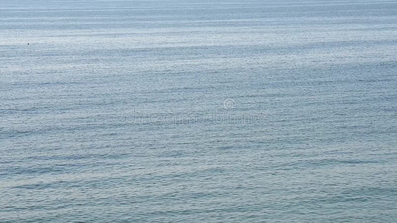 Calm Ocean Waves Gently Rolling Onto Sandy Beach with Bubbling Foam in ...