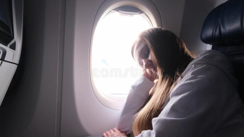 A Calm Passenger is Resting beside the Window on a Long Flight Stock ...