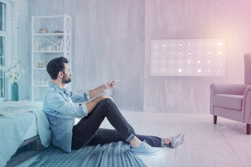 Calm Programmer Using Remote Control while Sitting at Home Stock Photo ...