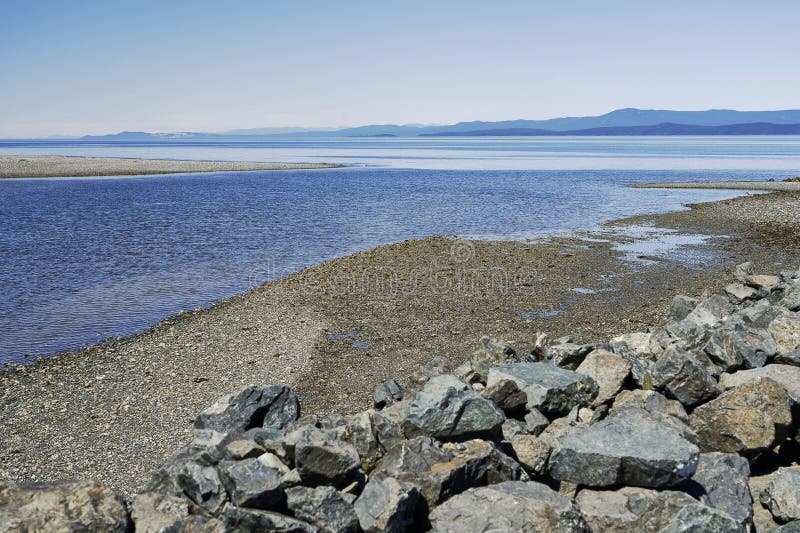 River Flowing into the Ocean with Rocks on the Bottom Right of the ...
